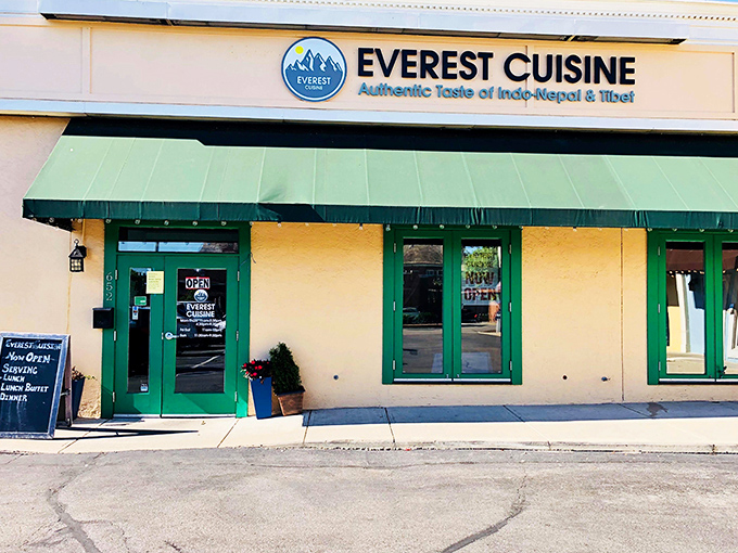 The unassuming exterior of Everest Cuisine belies the flavor explosion waiting inside. That green awning might as well be a portal to Kathmandu.