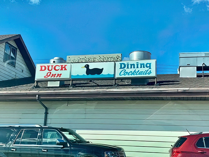 The classic roadside sign says it all: Duck Inn, Dining, Cocktails. Wisconsin's supper club tradition beckons from the rooftop.