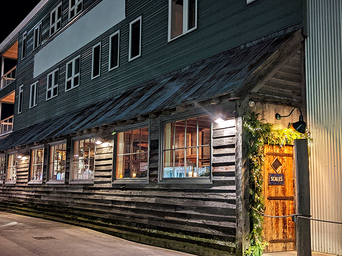 Scales' weathered wooden exterior glows with warm invitation at twilight, its rustic charm a perfect prelude to the seafood treasures waiting inside.