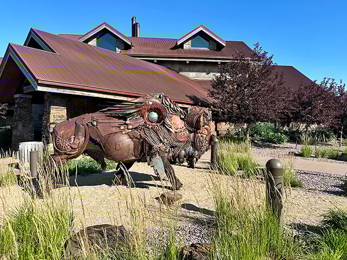 The iconic metal bison sculpture welcomes you like a rustic guardian of flavor, standing proud against the restaurant's stone and timber facade.