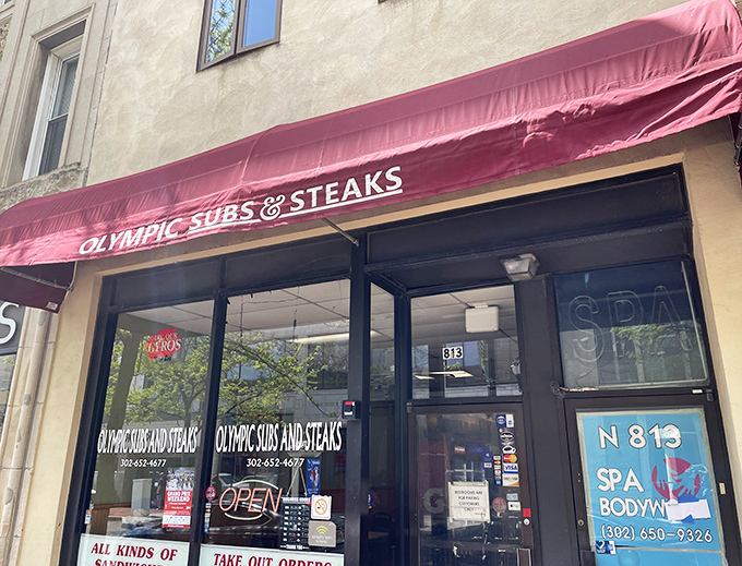 The unassuming red awning of Olympic Subs & Steaks beckons hungry Wilmington locals like a culinary lighthouse in a sea of downtown businesses.