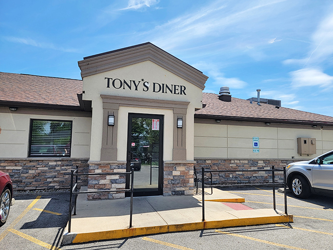 The stone-accented facade of Tony's Diner stands like a beacon of breakfast hope against the bright Illinois sky. No fancy frills, just the promise of good eating inside.