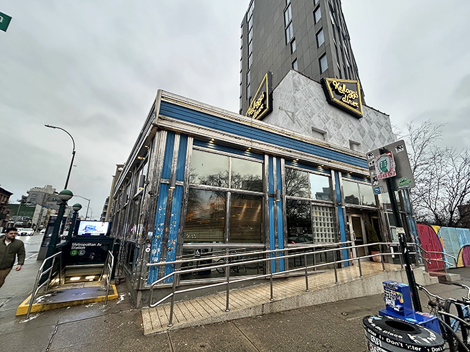 The gleaming blue-trimmed exterior of Kellogg's Diner stands like a beacon at Metropolitan and Union Avenues, promising comfort food salvation 24 hours a day.