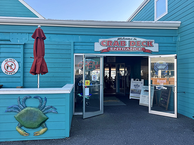 The turquoise beacon of seafood paradise sits proudly on the water, where ducks gather like eager food critics waiting for the day's special.