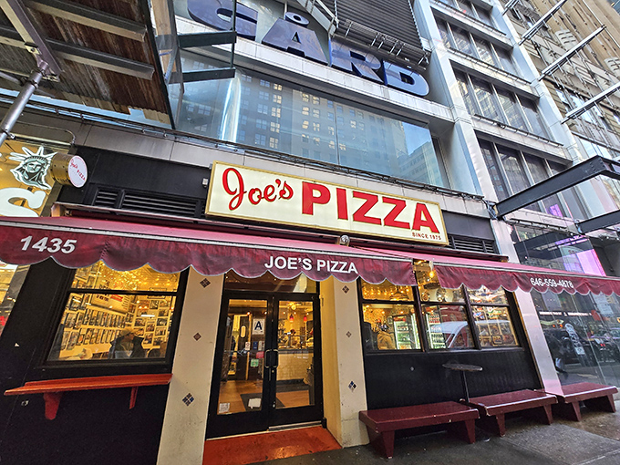The pilgrimage begins! Joe's Pizza on Broadway draws crowds under its iconic red awning—a beacon of hope for the pizza-obsessed in Midtown Manhattan.