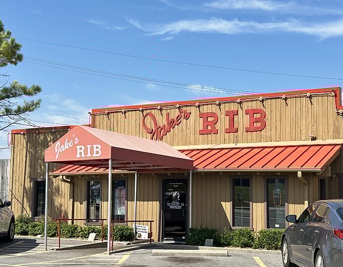 The unassuming wooden exterior of Jake's Rib with its bold red signage promises barbecue greatness without the fancy frills.