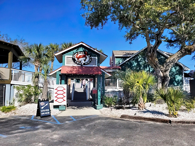 The teal-colored coastal charm of Shem Creek Crab House beckons seafood lovers like a siren song with palm trees providing the perfect South Carolina welcome.