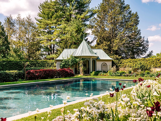 A storybook scene unfolds at Chanticleer Garden, where manicured blooms and a tranquil pool reflect pure serenity.