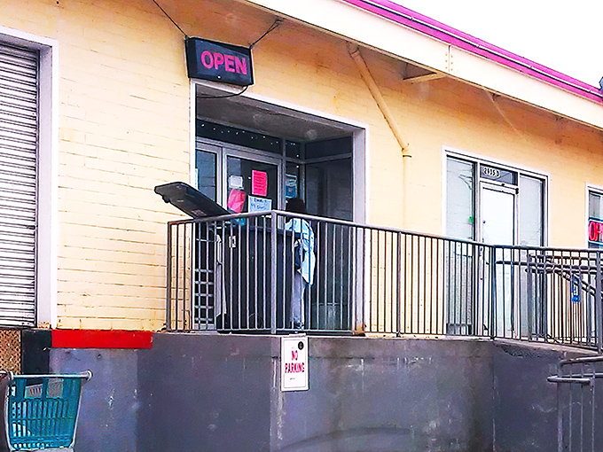 The neon "OPEN" sign beckons like a lighthouse for bargain hunters. This unassuming entrance hides a wonderland of treasures waiting to be discovered.