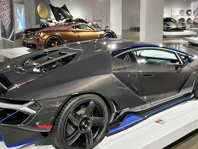 Sleek supercars gleam under perfect lighting, showcasing automotive artistry at its finest. The Lamborghini's angular silhouette whispers promises of speed and adventure.