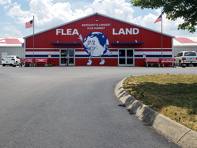 The iconic red exterior of Flea Land stands like a beacon for bargain hunters, complete with its globe-toting mascot welcoming treasure seekers to Kentucky's largest flea market.