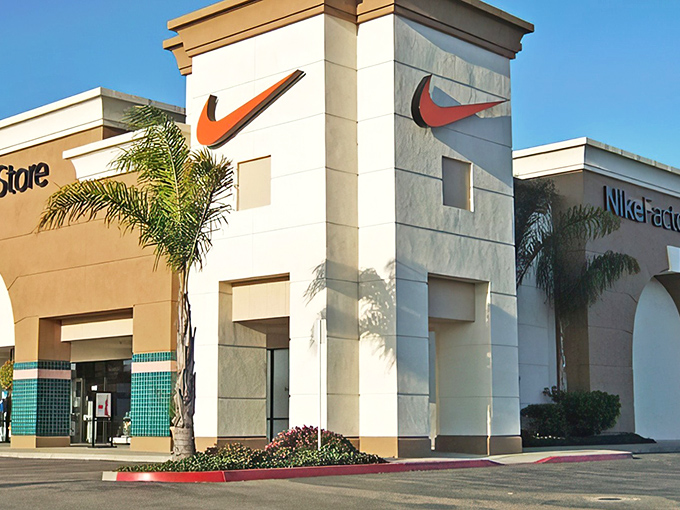 The iconic Nike swoosh welcomes bargain hunters like a retail lighthouse guiding ships to shore. California sunshine makes even outlet shopping feel like a vacation activity.
