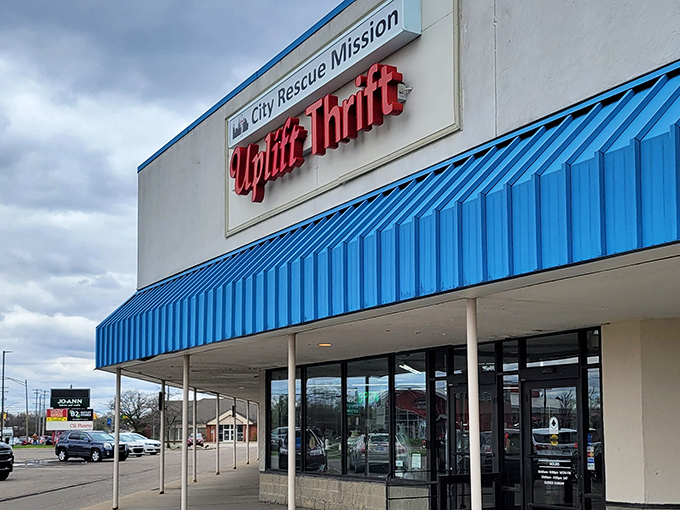 The bright blue awning of Uplift Thrift beckons like a retail oasis in Lansing, promising treasures within its unassuming exterior.