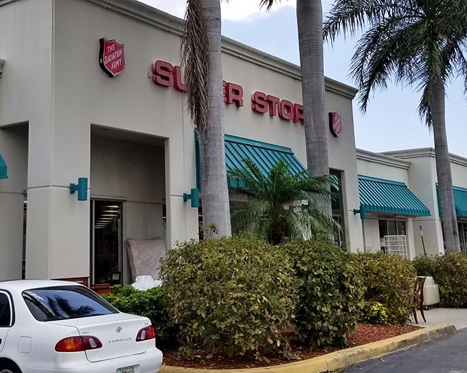 The Salvation Army Super Store stands proudly under Florida's blue skies, those teal awnings practically winking at bargain hunters like a tropical oasis of thrift.