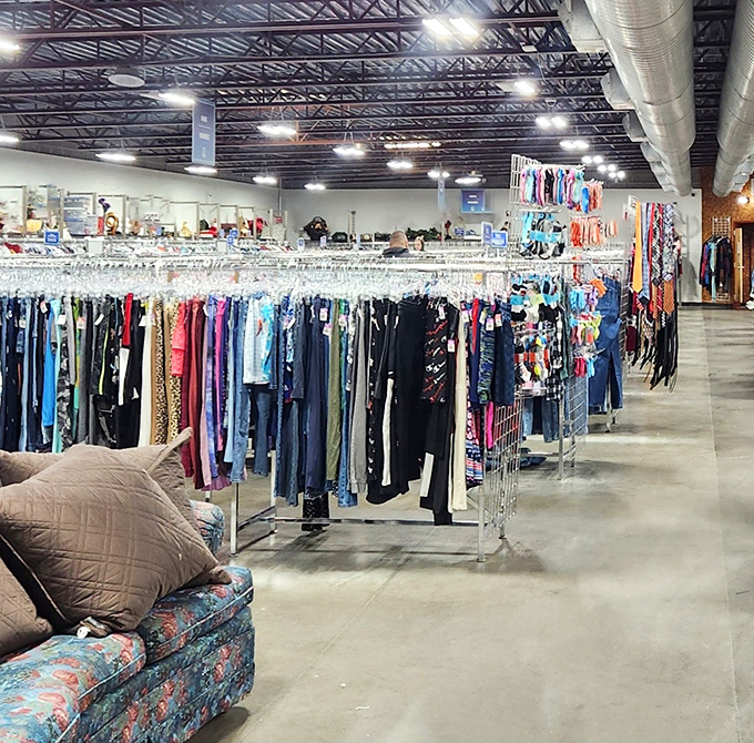 A treasure hunter's paradise awaits under those bright industrial lights. Row after row of carefully organized clothing racks stretch toward retail infinity.