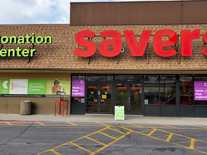 The iconic red Savers sign beckons like a lighthouse guiding bargain hunters to shores filled with secondhand treasures and unexpected finds.