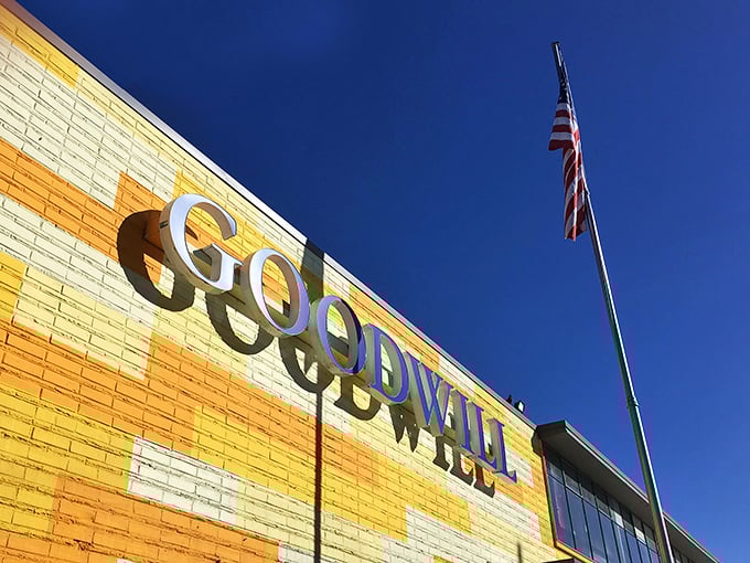 The iconic yellow and blue facade of Seattle Goodwill stands like a beacon of bargain possibilities against the Pacific Northwest sky.