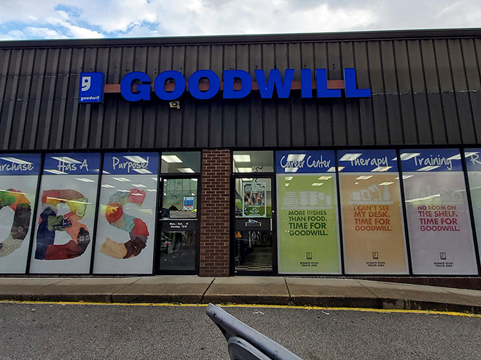 The iconic blue Goodwill sign beckons bargain hunters like a thrift store lighthouse guiding ships to treasure-filled shores.