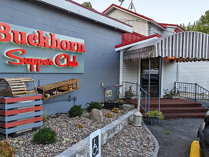 The iconic blue exterior with vintage red signage announces you've arrived somewhere special. Wisconsin's supper club tradition lives on behind these doors.