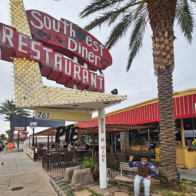 The iconic Southwest Diner sign stands like a neon-lit promise of culinary comfort, beckoning hungry travelers with its vintage charm and desert-framed welcome.