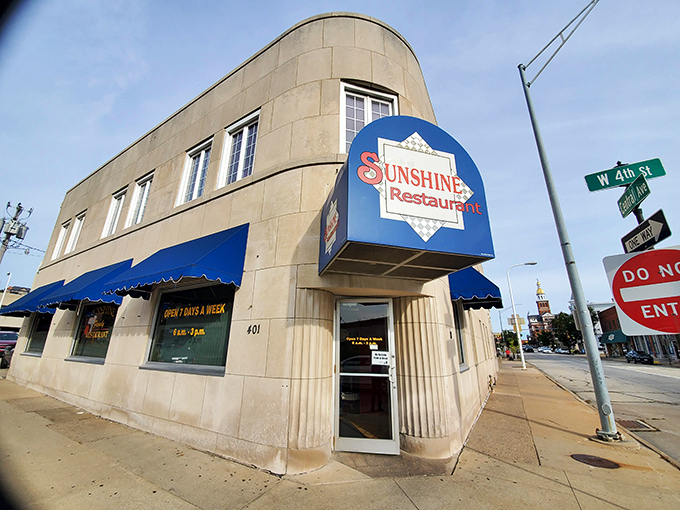 The iconic blue awning and distinctive curved architecture of Sunshine Restaurant stands as a beacon of comfort food in downtown Dubuque, where breakfast dreams come true.