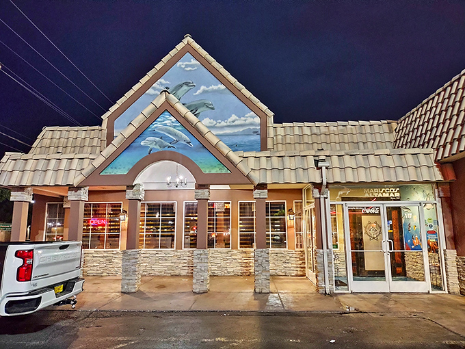 The dolphin mural crowning Mariscos Altamar's distinctive peaked roof is like a maritime beacon in Albuquerque's desert landscape—promising oceanic treasures within.