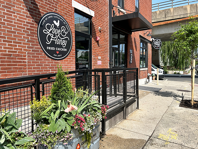 The brick-fronted charm of Love & Honey beckons from Northern Liberties, its round black sign promising crispy delights within those welcoming doors.