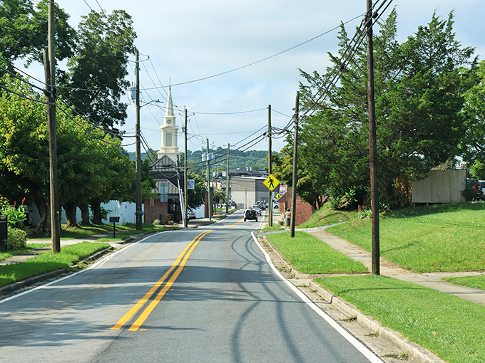 A classic small-town approach to Ellijay, where church steeples still punctuate the skyline and mountains frame the background like nature's own welcome sign.