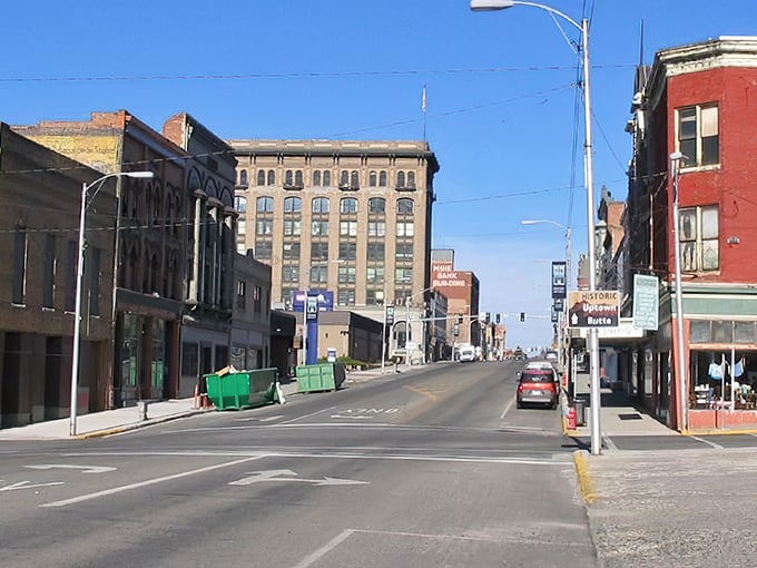Downtown Butte stands frozen in time, where historic brick buildings whisper stories of copper kings and mining fortunes against Montana's impossibly blue sky.