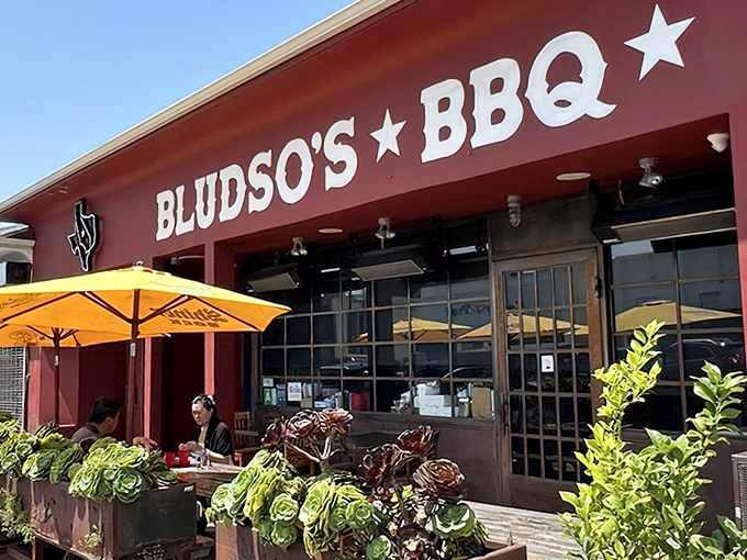 Bright yellow umbrellas welcome diners to this temple of Texas-style barbecue, where meat is religion and smoke is the holy spirit.