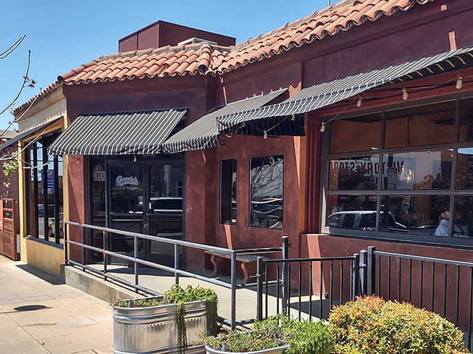 Terra cotta charm and striped awnings create that "where locals eat" vibe – the kind of place food pilgrims dream about discovering.