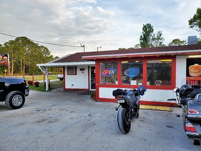 The humble red-trimmed exterior of The Red Top Pit Stop stands like a beacon for BBQ pilgrims, promising smoky delights within its unassuming walls.
