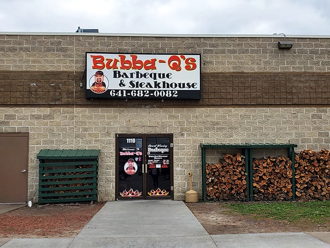 The unassuming exterior of Bubba-Q's in Ottumwa hides a smoky paradise within. That woodpile isn't just decoration—it's a promise of good things to come.