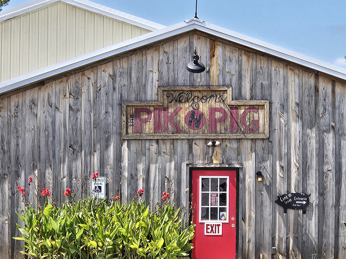 The weathered wooden exterior and bold red sign of Pik N Pig promise authentic barbecue without pretense&mdash;like a delicious secret hiding in plain sight.
