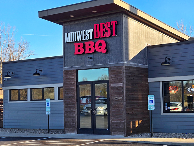 The bold red lettering against dark wood siding isn't just signage&mdash;it's a beacon for barbecue pilgrims seeking smoky salvation in Loveland.