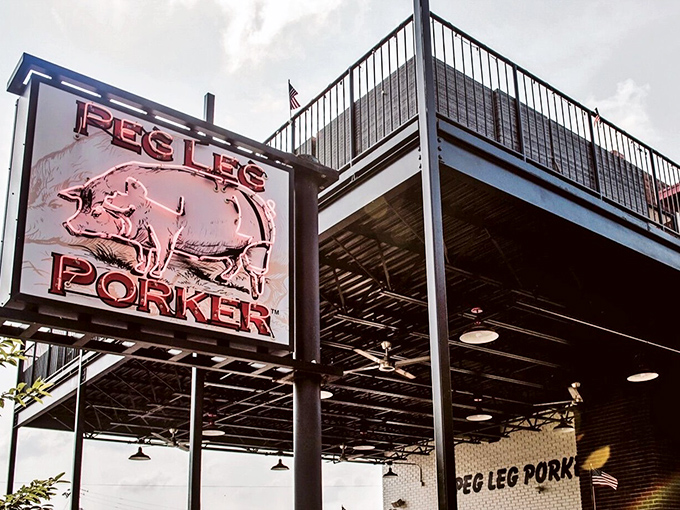 The neon pig sign beckons like a barbecue lighthouse in Nashville's Gulch. No fancy frills needed when the smoke speaks for itself.
