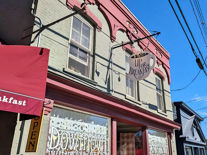 The iconic coffee cup sign beckons hungry travelers like a breakfast lighthouse on Manchester Center's Main Street. Worth climbing those stairs for!