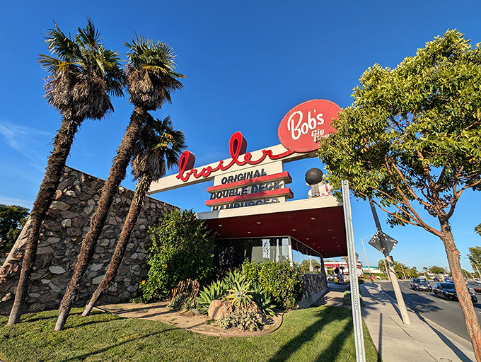 That iconic sign against the California blue sky isn't just advertising&mdash;it's a beacon of burger bliss promising nostalgic delights beneath those swaying palms.