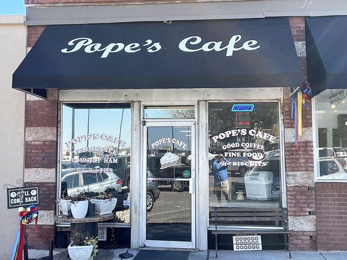 The iconic navy blue awning of Pope's Cafe stands as a beacon of comfort food in downtown Shelbyville, promising homestyle goodness within.