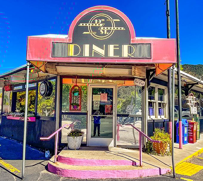 The iconic pink awning of 19th St. Diner stands out like a beacon of breakfast hope against Colorado's mountain backdrop. Resistance is futile.