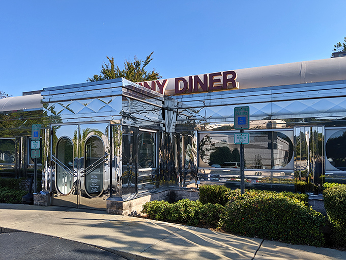The chrome exterior of The Shiny Diner gleams in the sunlight like a beacon of breakfast hope on Buck Jones Road.