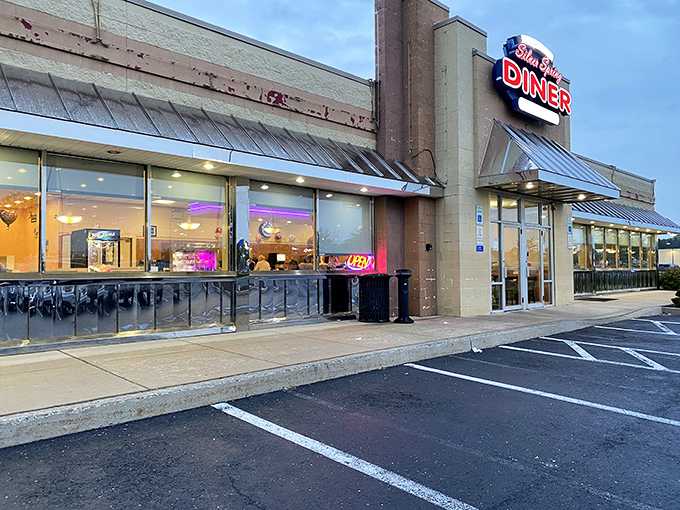 Twilight transforms this unassuming diner into a purple-hued temple of comfort food, where breakfast dreams come true regardless of what your watch says.