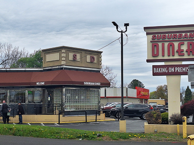 The classic diner silhouette against Pennsylvania sky &ndash; a beacon of breakfast hope where both Mercedes and pickup trucks gather at dawn.