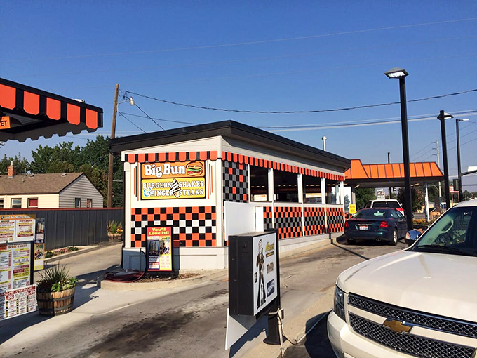 The iconic orange and black checkerboard exterior of Big Bun Drive In stands as a beacon of burger bliss in Boise, where time seems deliciously frozen.