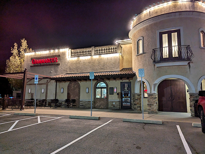 Giammarco's Mediterranean-inspired exterior glows like a beacon of culinary promise in the evening, its warm stucco walls and red sign inviting hungry travelers inside.