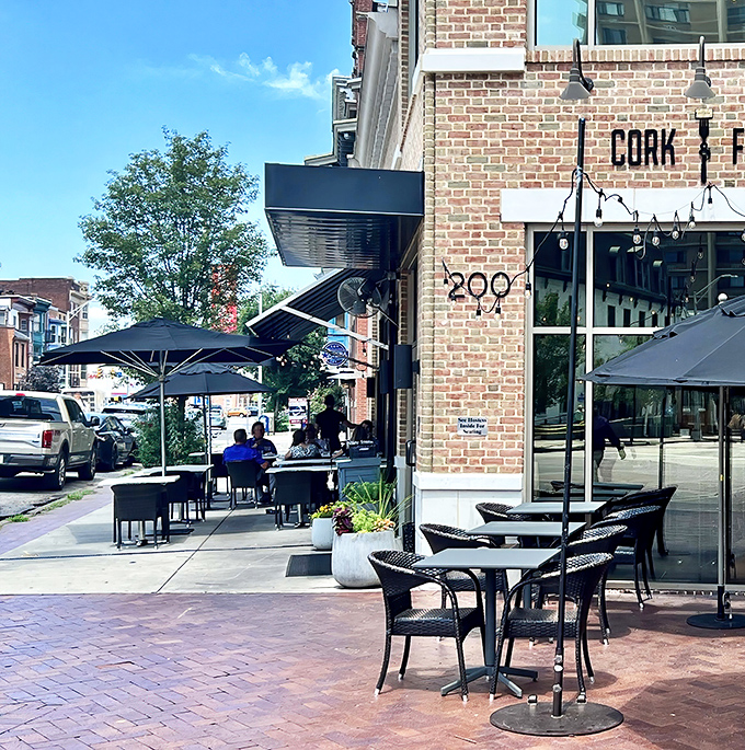 Cork & Fork's inviting brick exterior welcomes you with promise of culinary adventures. The outdoor seating area practically begs you to linger over a glass of wine.