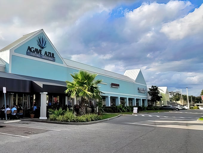 The striking turquoise exterior of Agave Azul stands out like a tropical oasis in the Orlando shopping center landscape, promising authentic Mexican flavors inside.