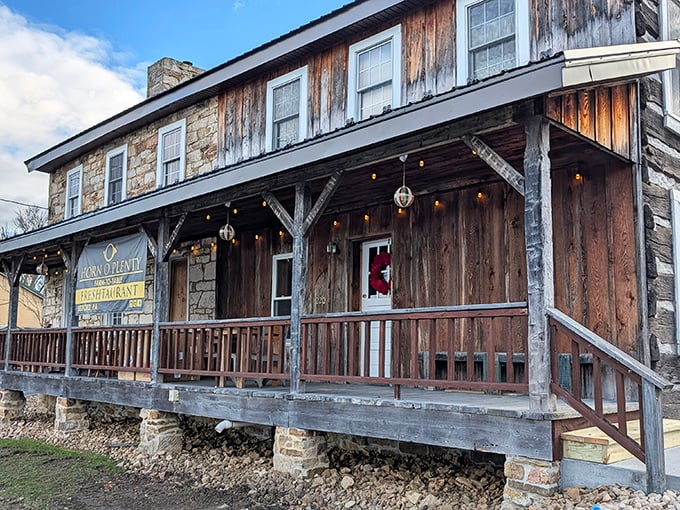 The rustic log cabin exterior of Horn O' Plenty welcomes you like an old friend, complete with colorful flower baskets that say "come on in, the pizza's waiting."