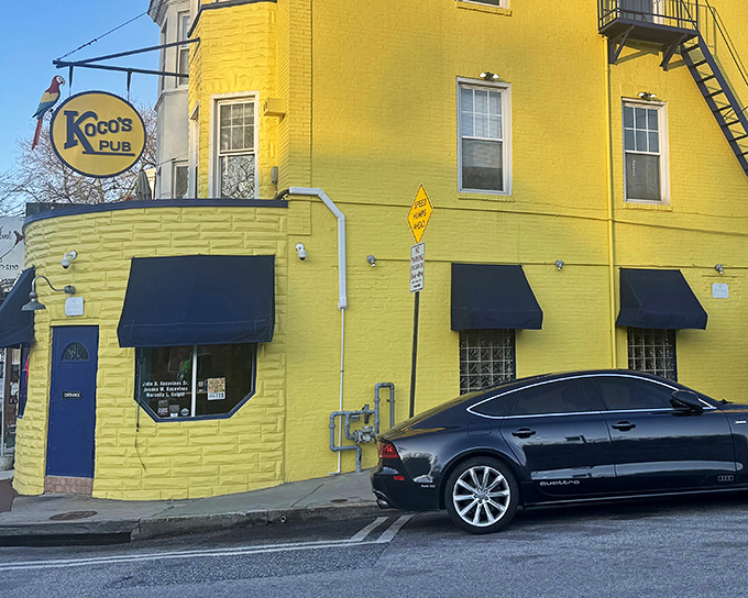 The sunshine-yellow exterior of Koco's Pub isn't just eye-catching&mdash;it's practically a lighthouse guiding hungry sailors to crab cake paradise in Baltimore's urban landscape.