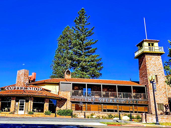 The iconic stone tower of The Steakhouse rises against Paso Robles' impossibly blue sky, promising carnivorous delights within its Spanish-style walls.